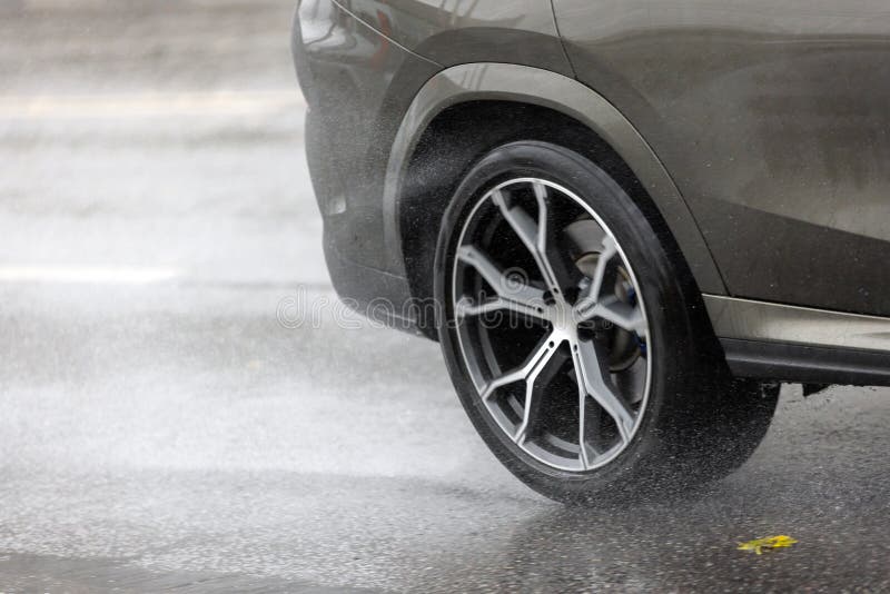Rain Water Splashing Flows from Wheels of Grey Car that Moving Fast on ...