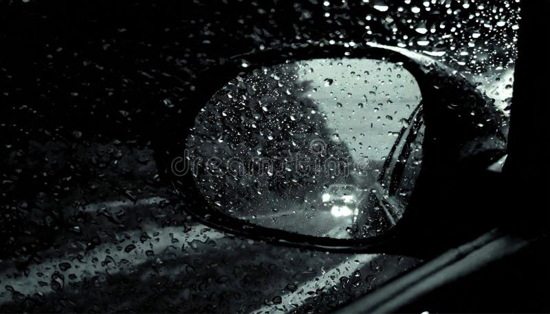 Rain Water on Windscreen Reflection in Car Mirror. Water Drops on Wet ...