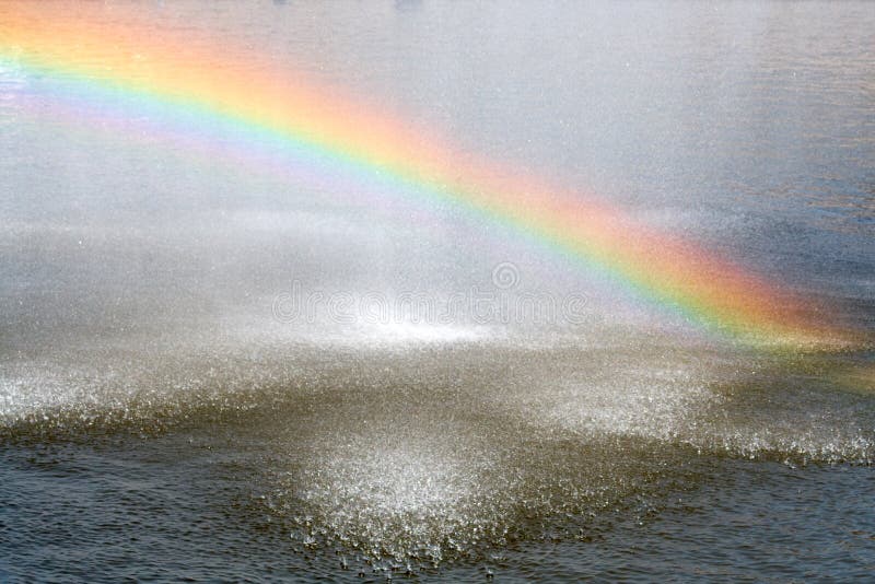 Rainbow Above Water Surface. Rainbow from City Fountain Splash Water ...