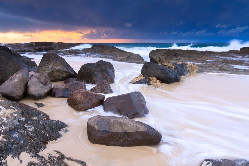 Rainbow bay beach stock photo. Image of sundown, rock - 26817580