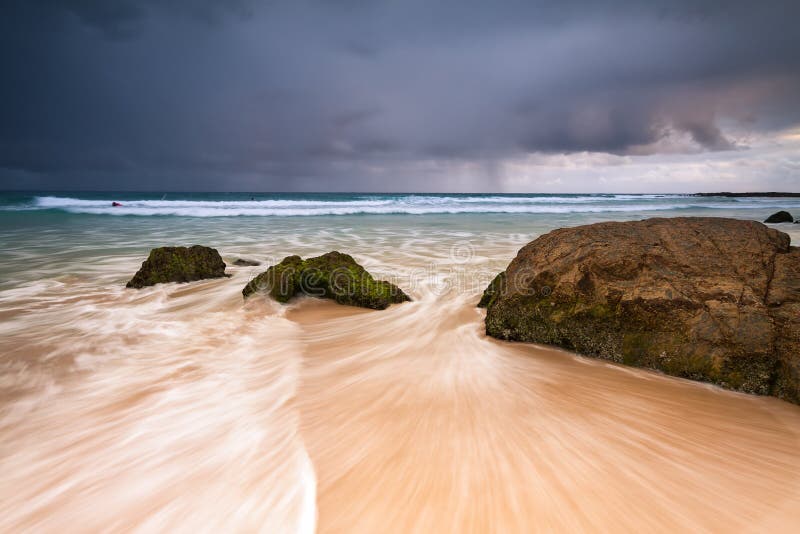 Rainbow bay beach at dawn stock image. Image of cloud - 23848567