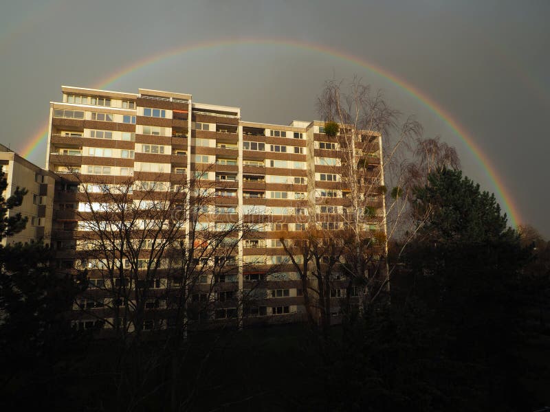 Rainbow Behind Skyscraper with Dark Sky Stock Image - Image of nature ...