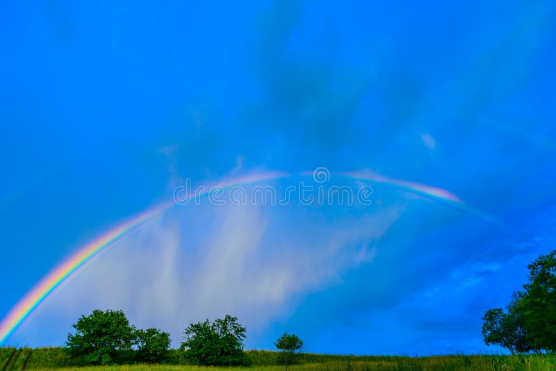 Rainbow in a Blue Sky after the Rain Stock Image - Image of rainbow ...