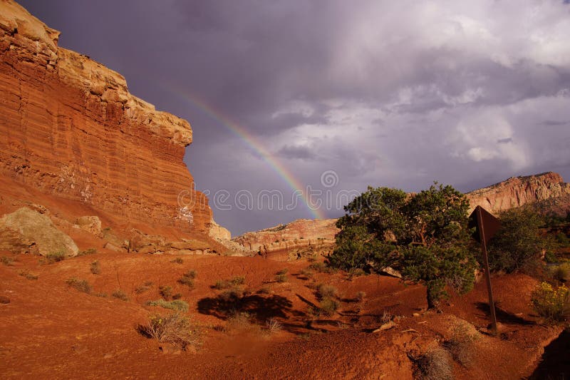 Rainbow and Brief Dramatic Sunshine Stock Photo - Image of dark, clouds ...