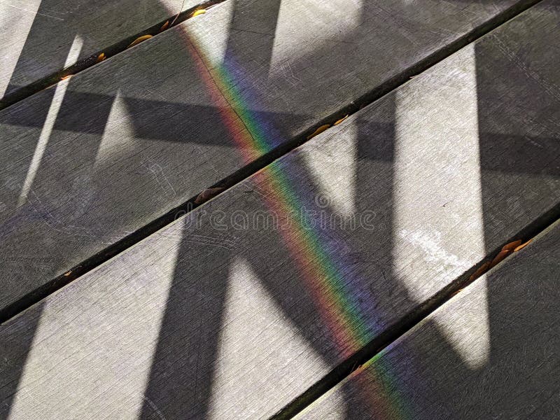 Rainbow Cast Over Harsh Black Shadows on an Outdoor Patio Stock Photo ...