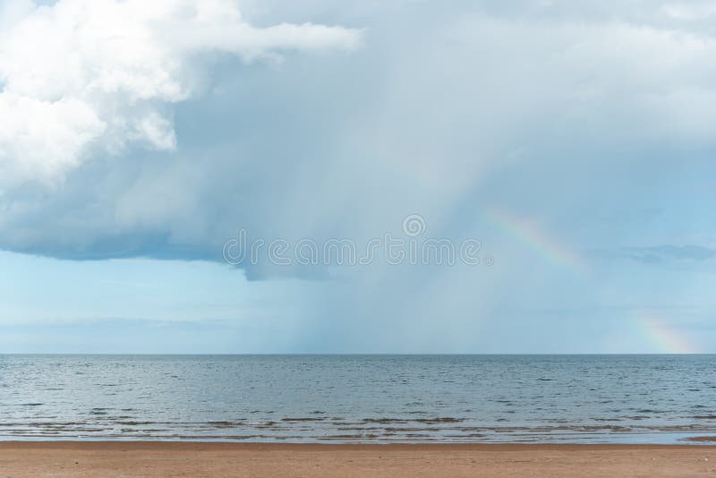 Rainbow over the sea stock photo. Image of nature, storm - 193347480