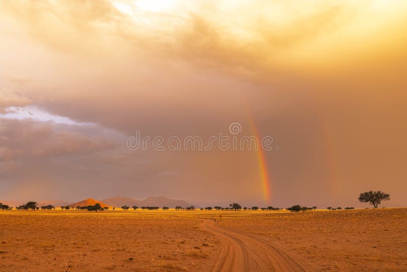 Rainbow and Clouds Above Dry Desert Sand Stock Image - Image of ...