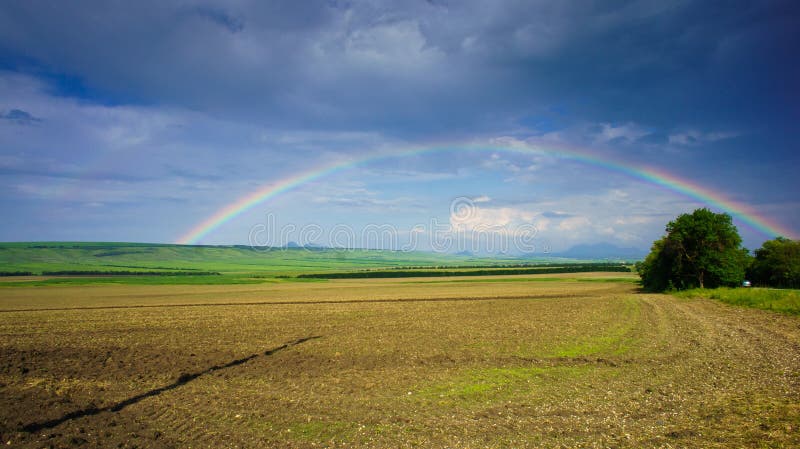 Rainbow with Clouds Over Farm Field Stock Image - Image of rainbow ...