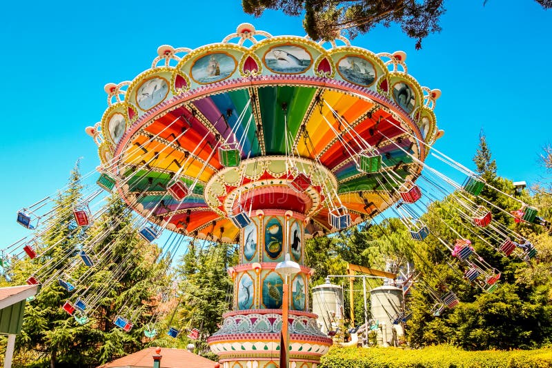 A Rainbow Colored Swing Carousel at an Amusement Park. Stock Photo ...