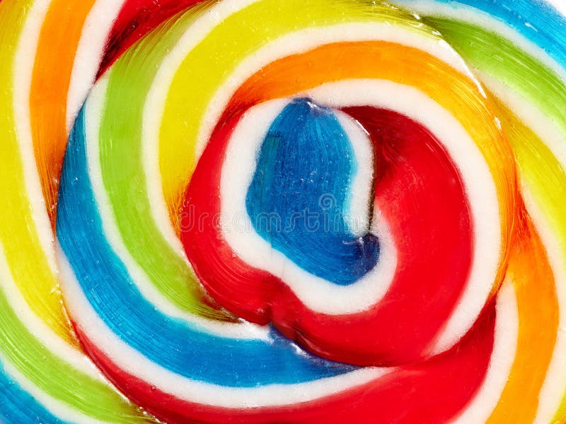Rainbow Colored Swirl Round Candy Lollipop on Red Background. Close Up ...