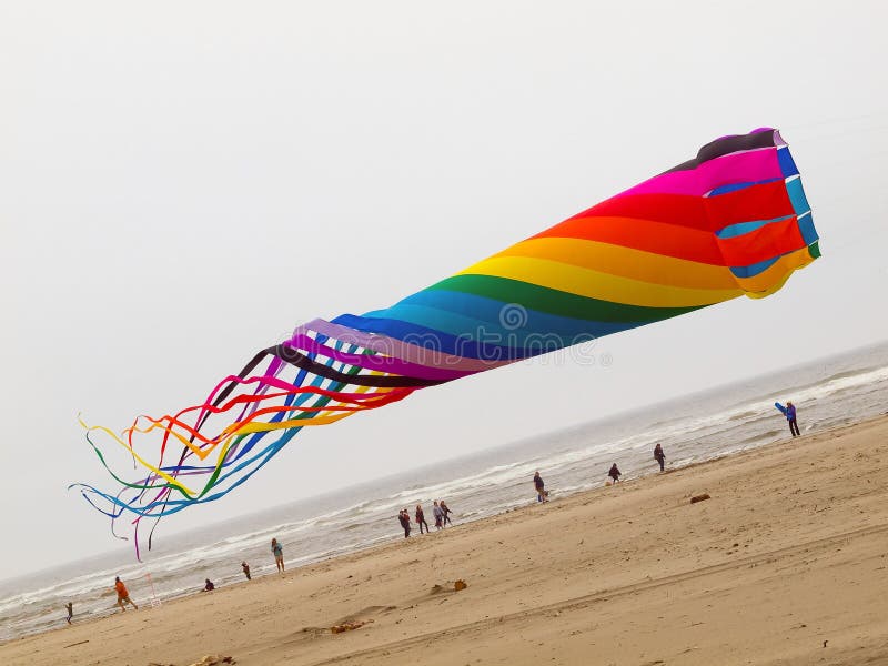 Rainbow Colored Tube Kite Flying Stock Image - Image of outside, grass ...