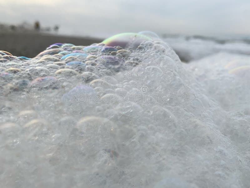 Rainbow Coloured Foam on the Beach Stock Image - Image of glass, winter ...