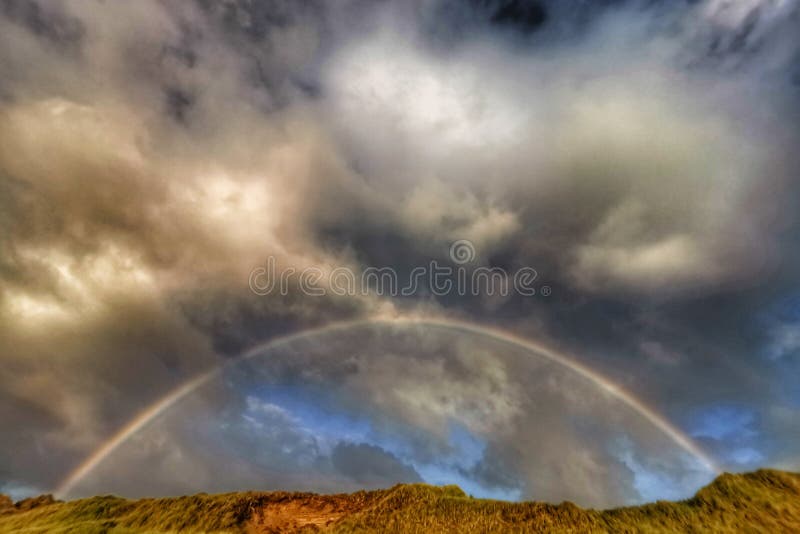 Rainbow in the Dunes stock photo. Image of clouds, dunes - 177517356
