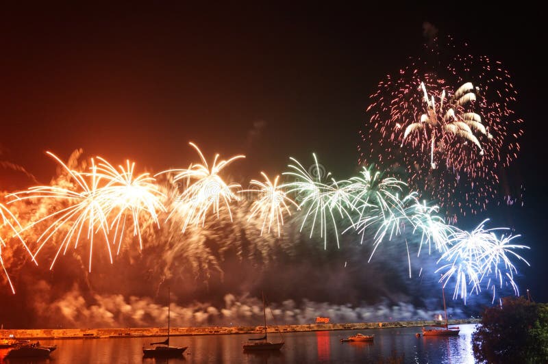 Rainbow fireworks! stock image. Image of fireworks, water - 42924523