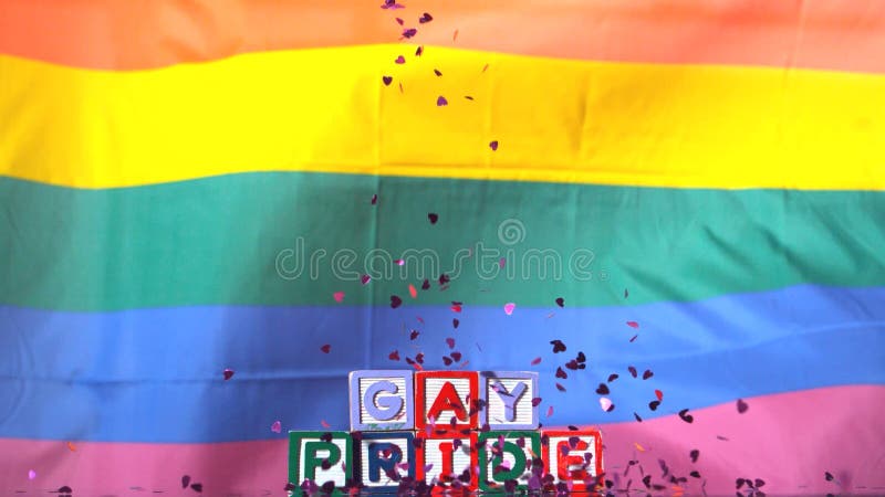 Rainbow Flag Moving in the Breeze with Gay Pride Blocks and Confetti ...