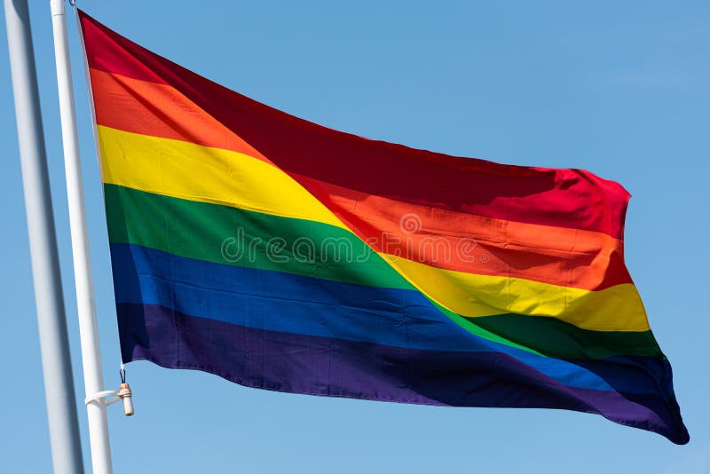 Rainbow Flag Waving in the Breeze Stock Photo - Image of colorful ...