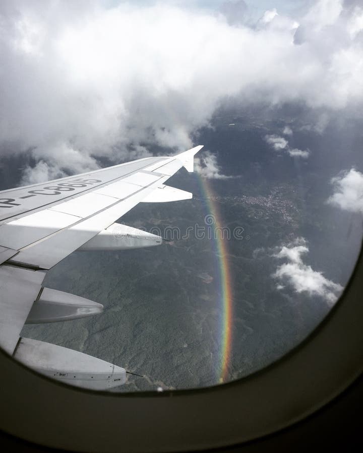 Rainbow while on a flight editorial photo. Image of window - 117103751