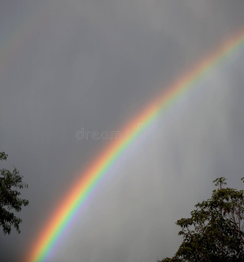 Rainbow on grey clouds stock photo. Image of above, dramatic - 26713332