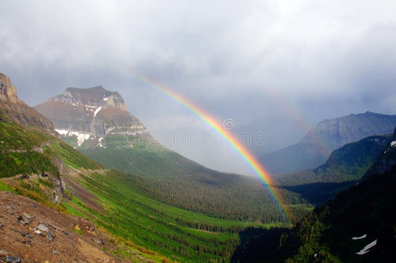 Rainbow on Blue Sky Over the Green Forest and Mountains Stock Image ...