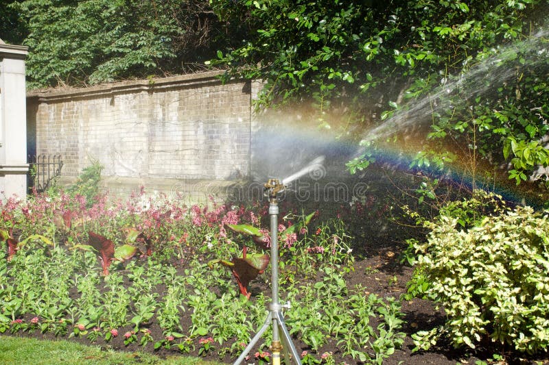 A Rainbow Occurring through a Water Spray Stock Image - Image of garden ...