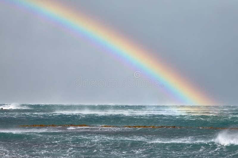Rainbow over sea stock photo. Image of high, open, raining - 297348376