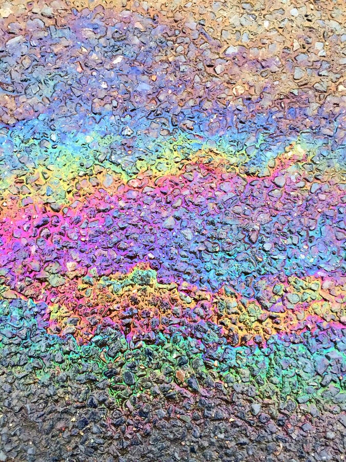 Rainbow Oil Slick on a Road Stock Photo - Image of petroleum ...