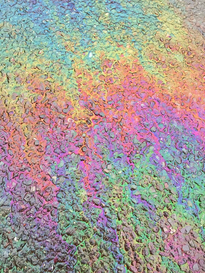 Rainbow Oil Slick on a Road Stock Photo - Image of petroleum ...