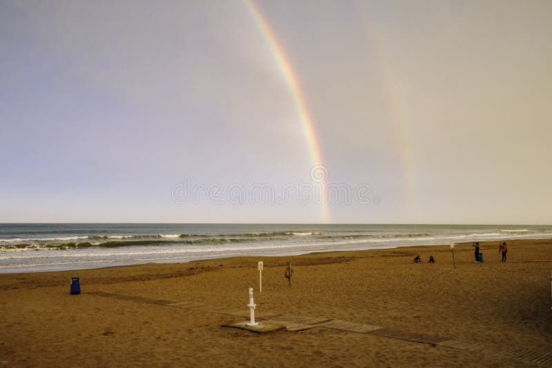 Rainbow Over the Beach on a Rainy Afternoon Stock Image - Image of ...