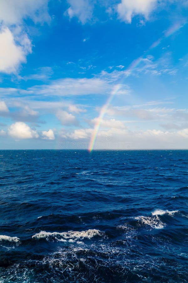 Rainbow Over Blue Sea stock photo. Image of clouds, natural - 79633566