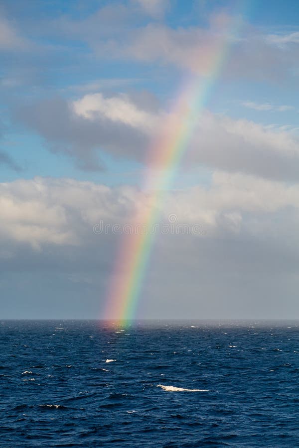 Rainbow Over Blue Sea Vertical Stock Image - Image of beautiful, cloud ...