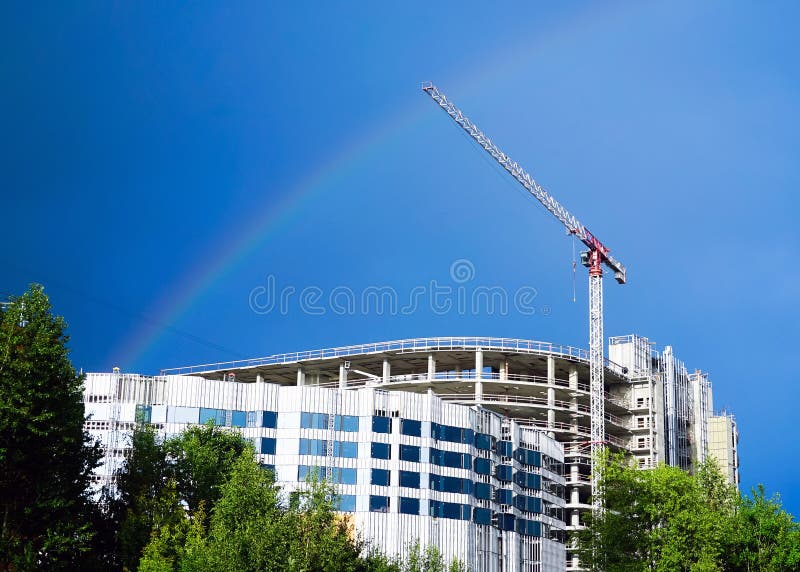 Rainbow Over the Building Under Construction and Construction Crane ...