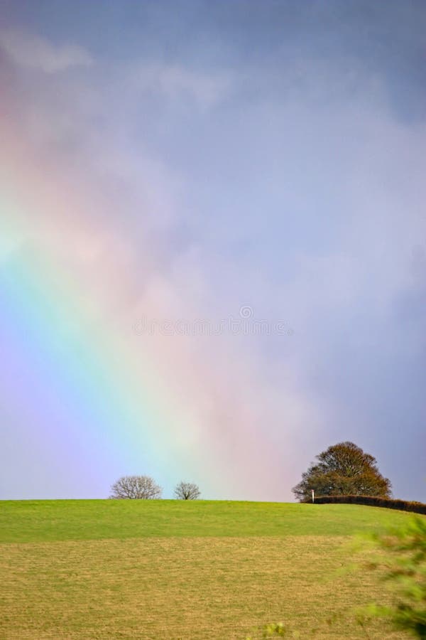 Rainbow over a field stock image. Image of cloud, field - 121222309