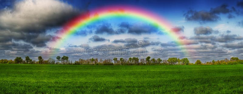 Rainbow over the field stock image. Image of clouds - 165750263