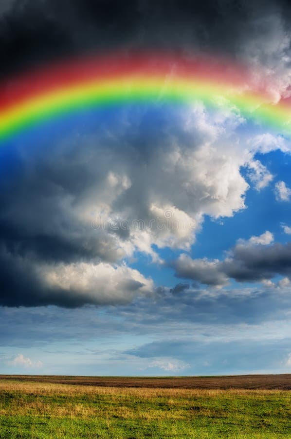 Rainbow over the field stock image. Image of arch, lawn - 165750331