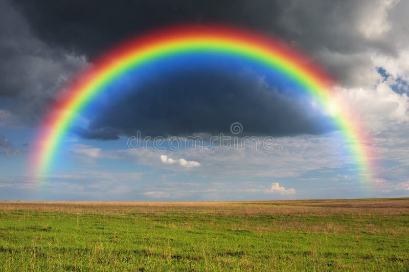 Rainbow over the field stock photo. Image of natural - 165750368