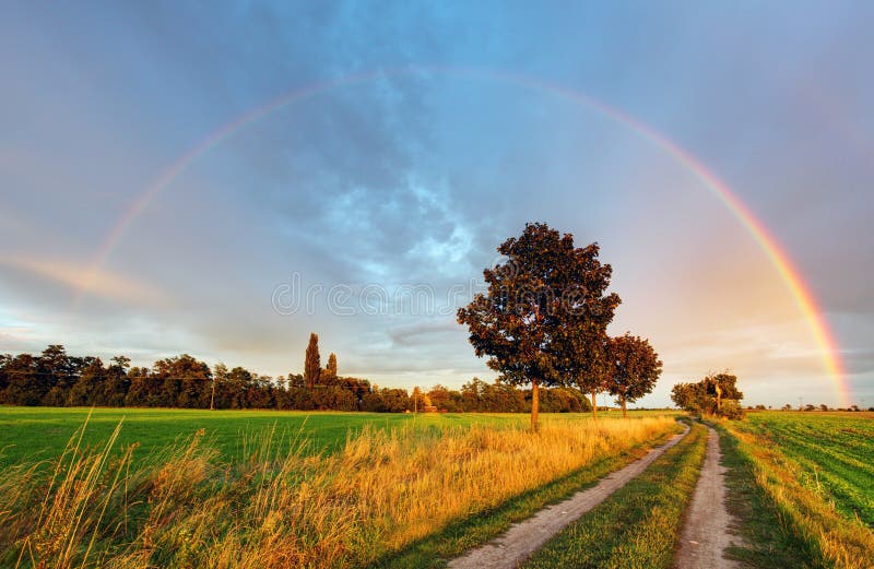 Rainbow over field road stock image. Image of beautiful - 33797067
