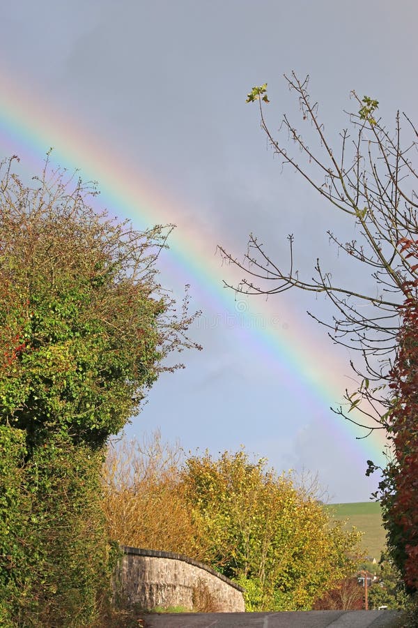 Rainbow over fields stock photo. Image of rainbow, cloud - 117161332