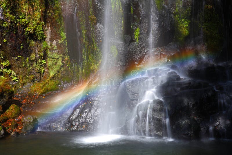 A Rainbow Over the Flow of a Waterfall Stock Photo - Image of coastal ...