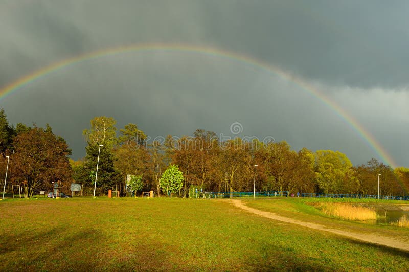 A Rainbow Over the Forest in a Dramatic Dark Sky after the Storm Has ...