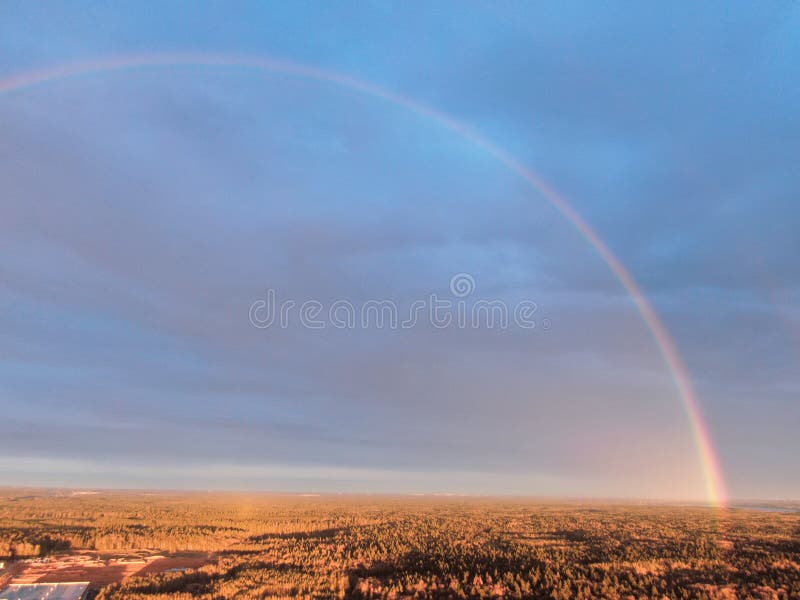 A Rainbow Over the Forest at Sunset from a High Altitude. Beautiful ...