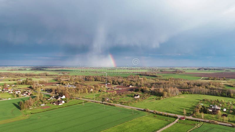 The Rainbow Over the Green Field after Storm with Rain, during Spring ...