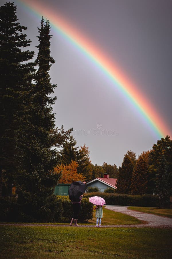 Rainbow Over a Green Park and People with Umbrellas Stock Photo - Image ...