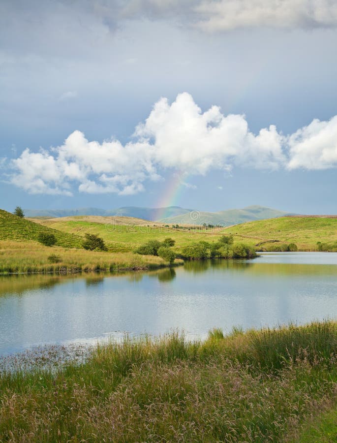 Rainbow over a lake stock photo. Image of weather, boathouse - 26444328