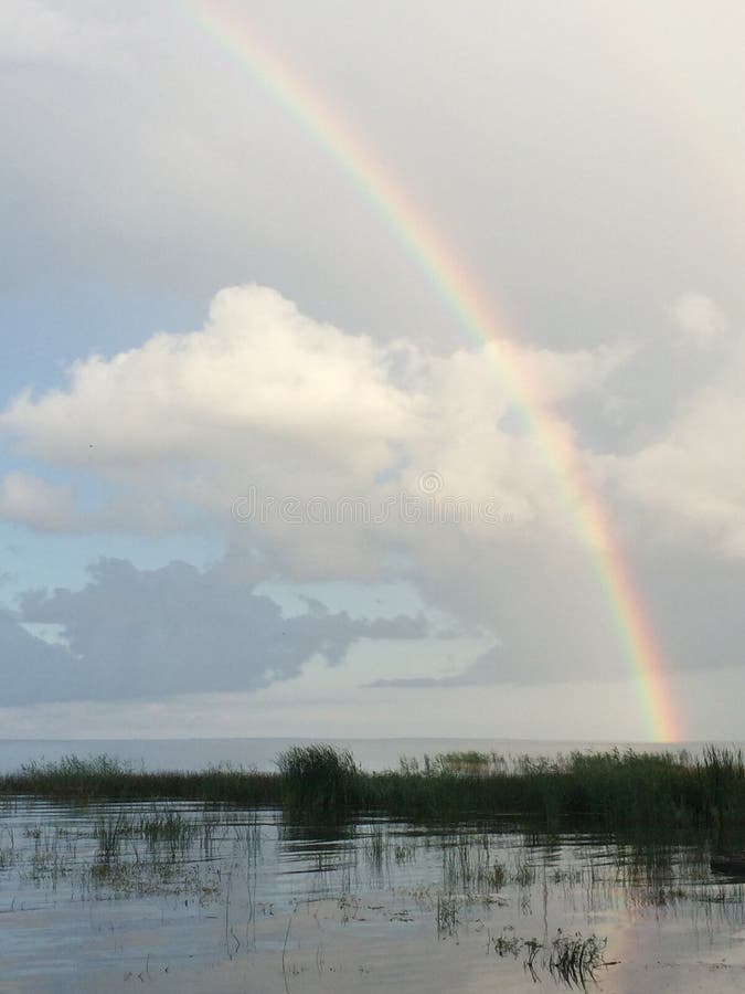 Rainbow Over Lake with Clouds Stock Photo - Image of lake, clouds: 49839082