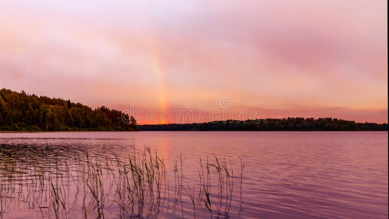 Rainbow Over the Lake at Sunset Stock Photo - Image of rain, light ...
