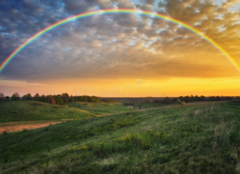 Rainbow over the meadow stock image. Image of climate - 188097699