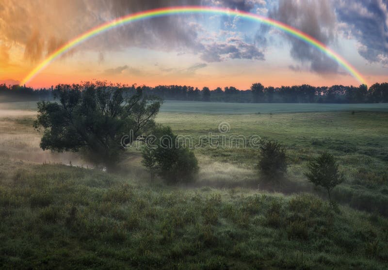 Rainbow Over a Meadow in the Spring Stock Photo - Image of glowing ...