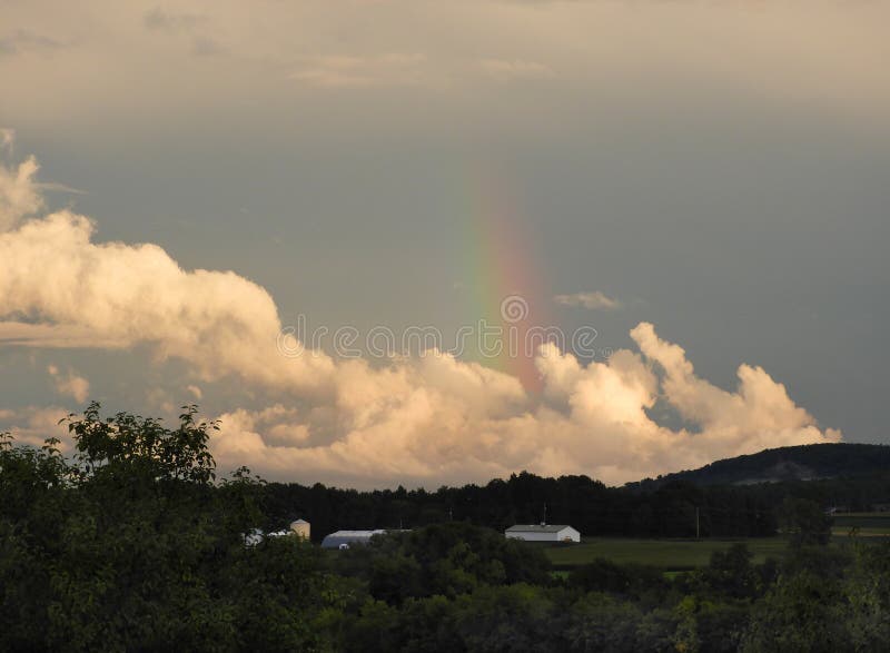 Rainbow Above Cumulus Clouds in NewYorkState Countryside Stock Image ...