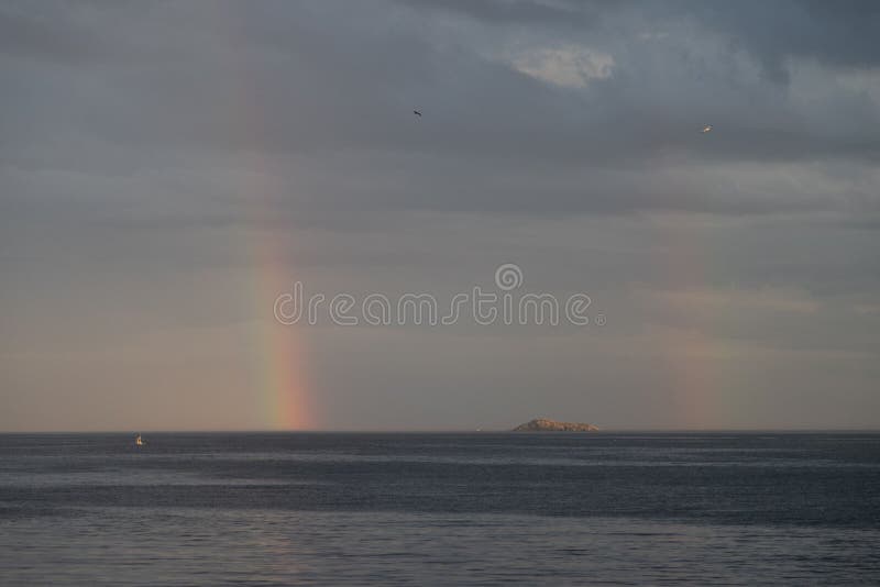 Rainbow Over Ocean at Sunset Stock Photo - Image of ocean, sunset ...