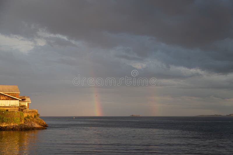 Rainbow Over Ocean at Sunset Stock Photo - Image of stormy, reflection ...